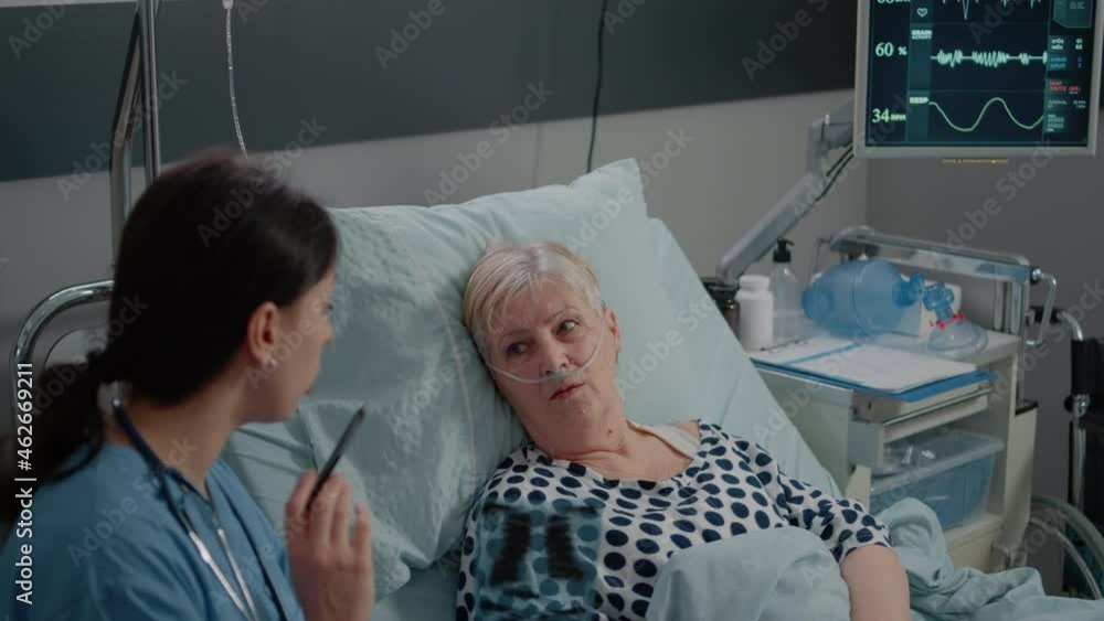 Woman nurse holding x ray scan to old patient for diagnosis and results ...