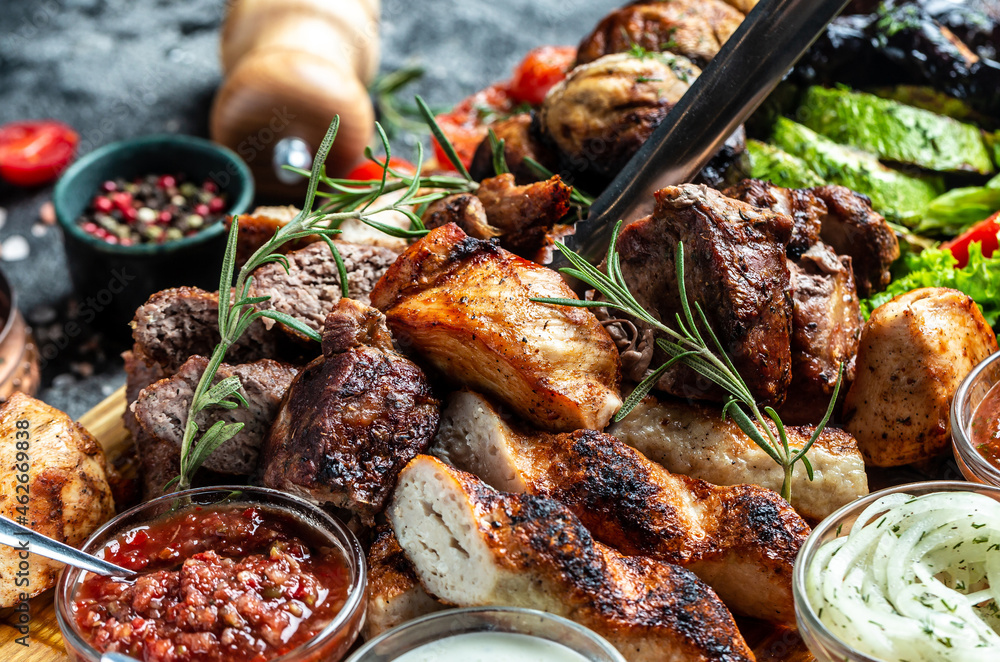 Mixed grilled meat platter. Barbecue menu. Grilled meat and vegetables ...