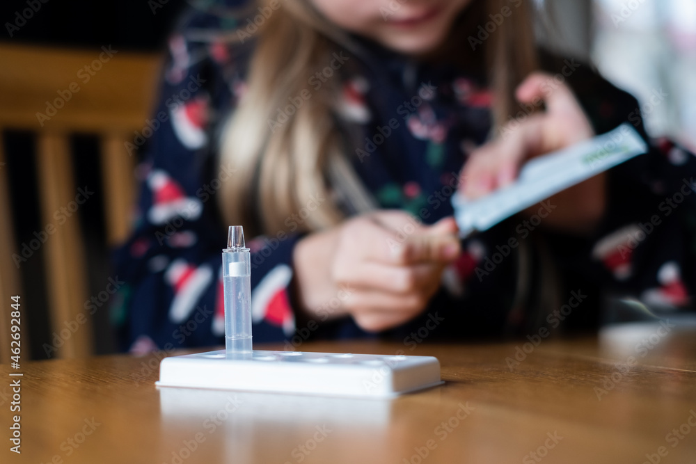 Child testing herself for coronavirus at home in the morning before ...