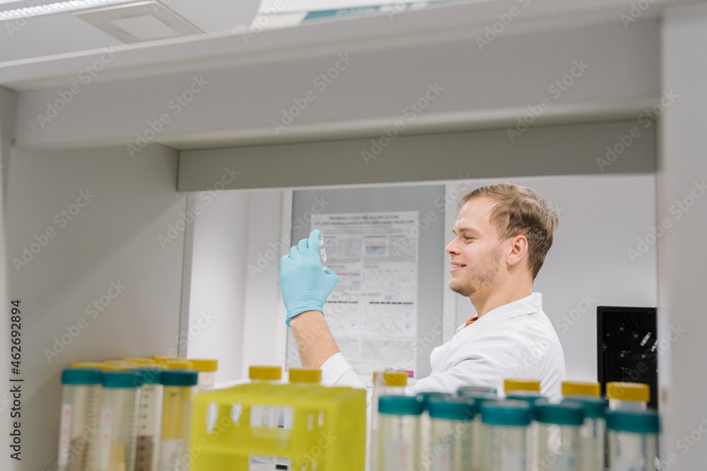 Smiling scientist analyzing a specimen in laboratory Stock Photo ...