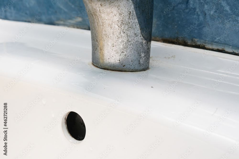 A part of dirty faucet with limescale, calcified water tap with lime ...