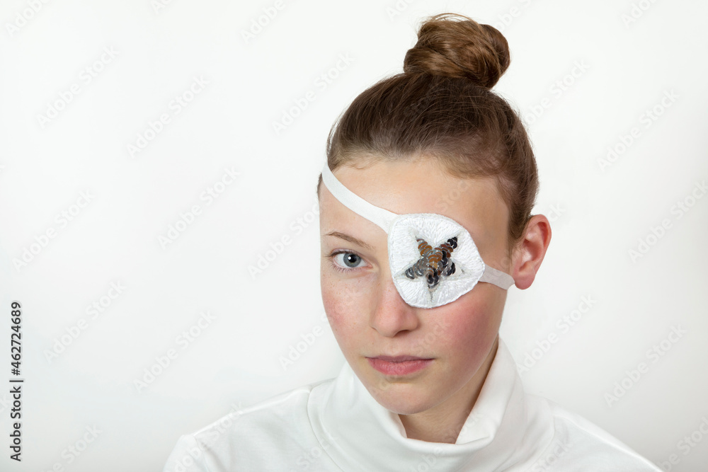 Portrait of teenage girl with bun wearing eye patch Stock Photo | Adobe ...