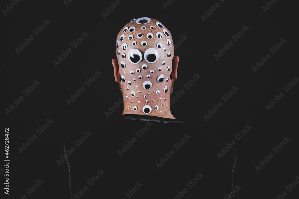 Bald man with head covered in googly eyes Stock Photo | Adobe Stock