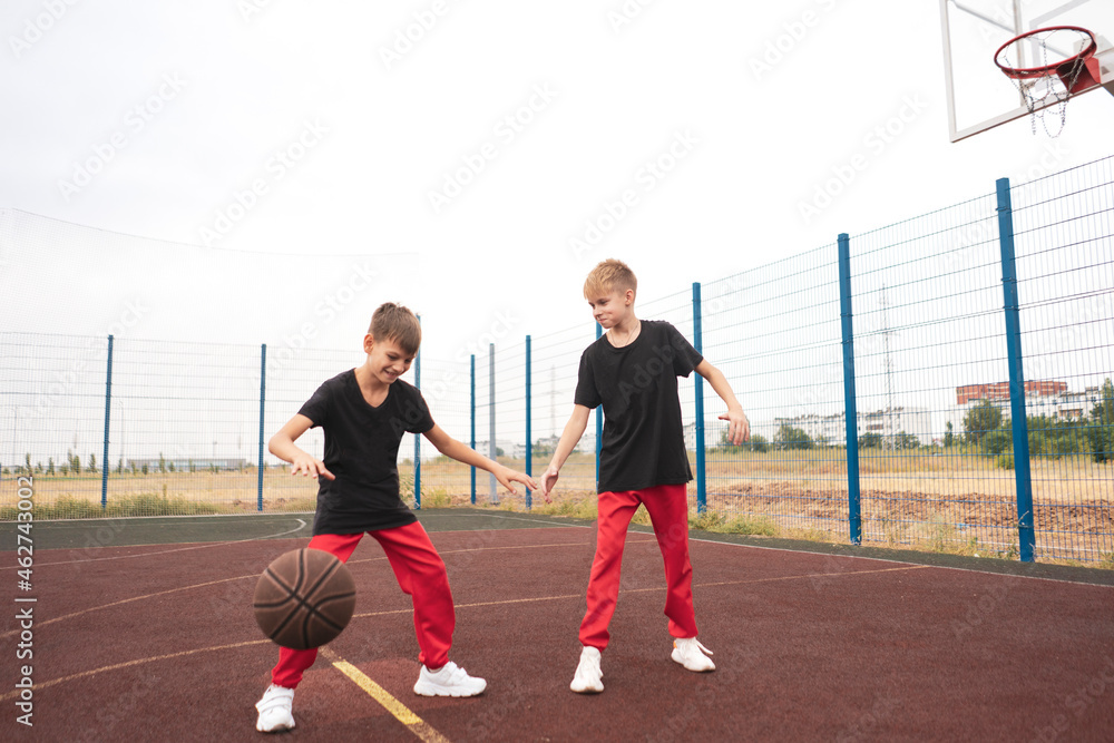 two male kids playing 1 vs 1 basketball game outdoors foto de Stock ...
