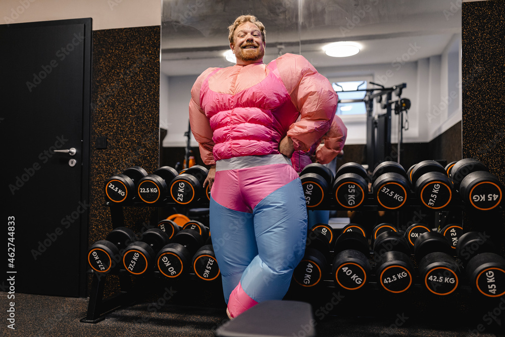 Proud man wearing pink bodybuilder costume in gym Stock Photo | Adobe Stock