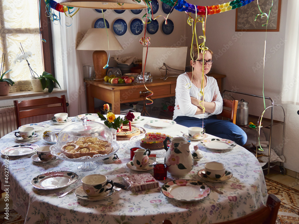 Woman in bad mood waiting at laid table for guests Stock Photo | Adobe ...