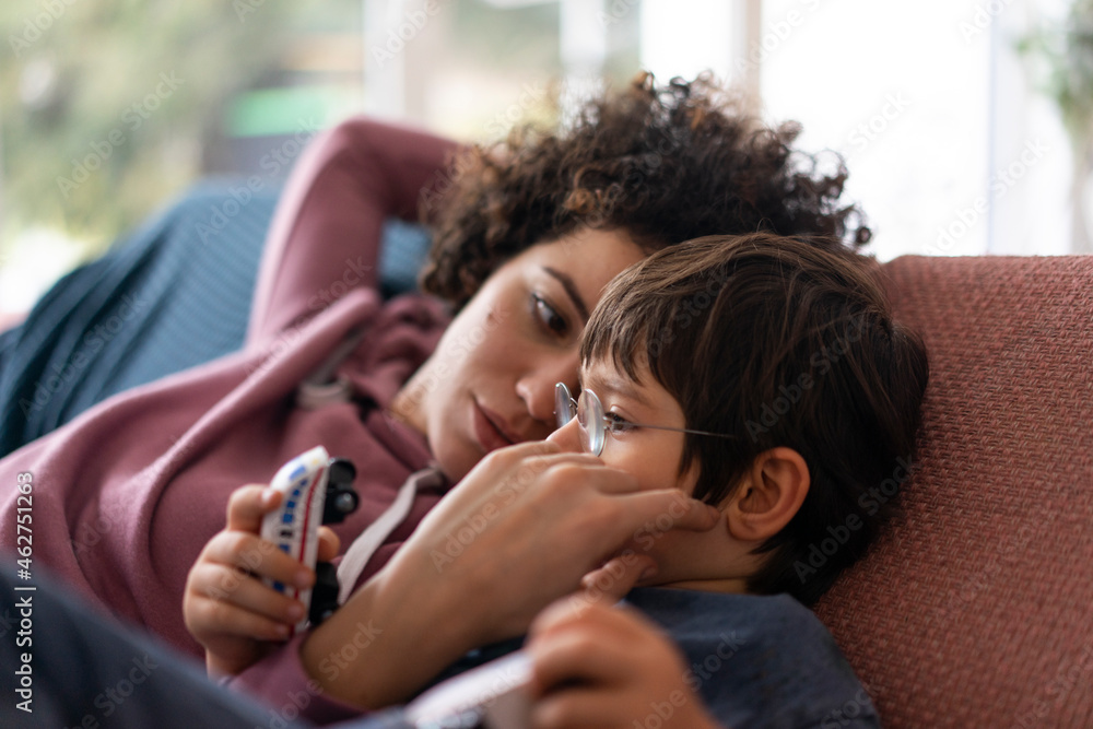 Family cuddling on couch Stock Photo | Adobe Stock