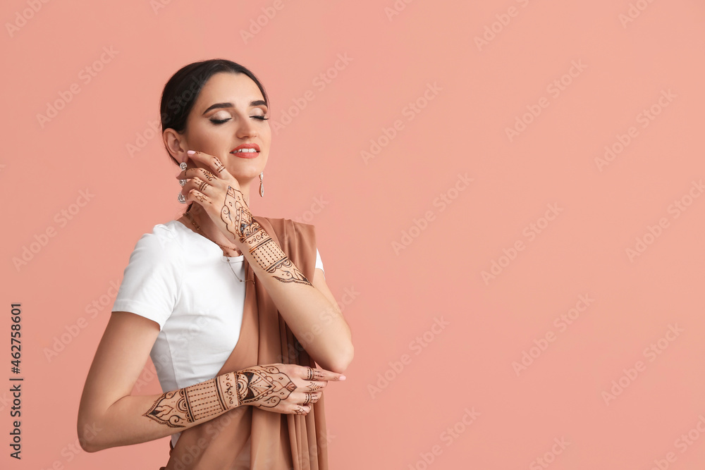 Beautiful Indian woman with henna tattoo on color background Stock ...