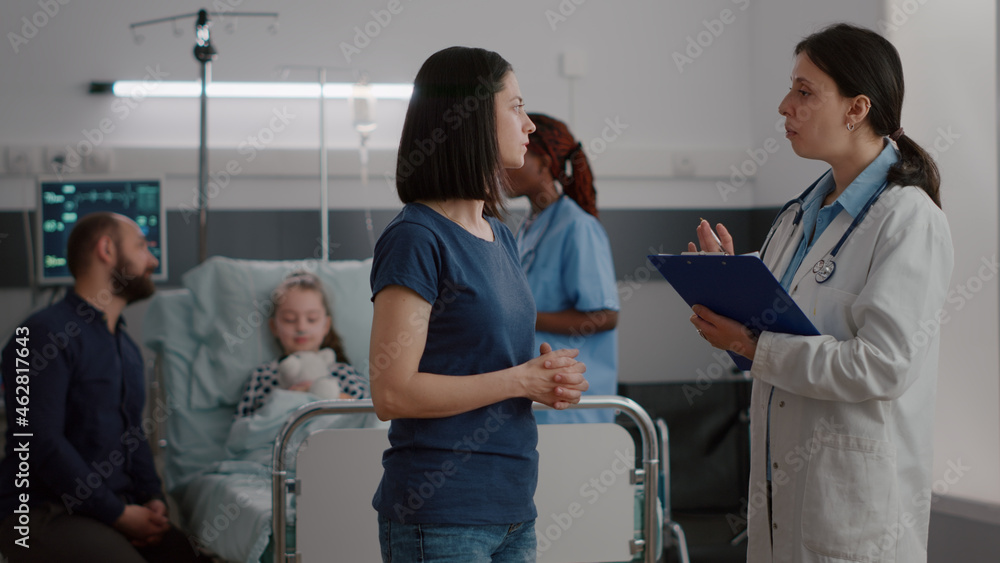 Pediatrician woman doctor explaining recovery treatment to worried ...