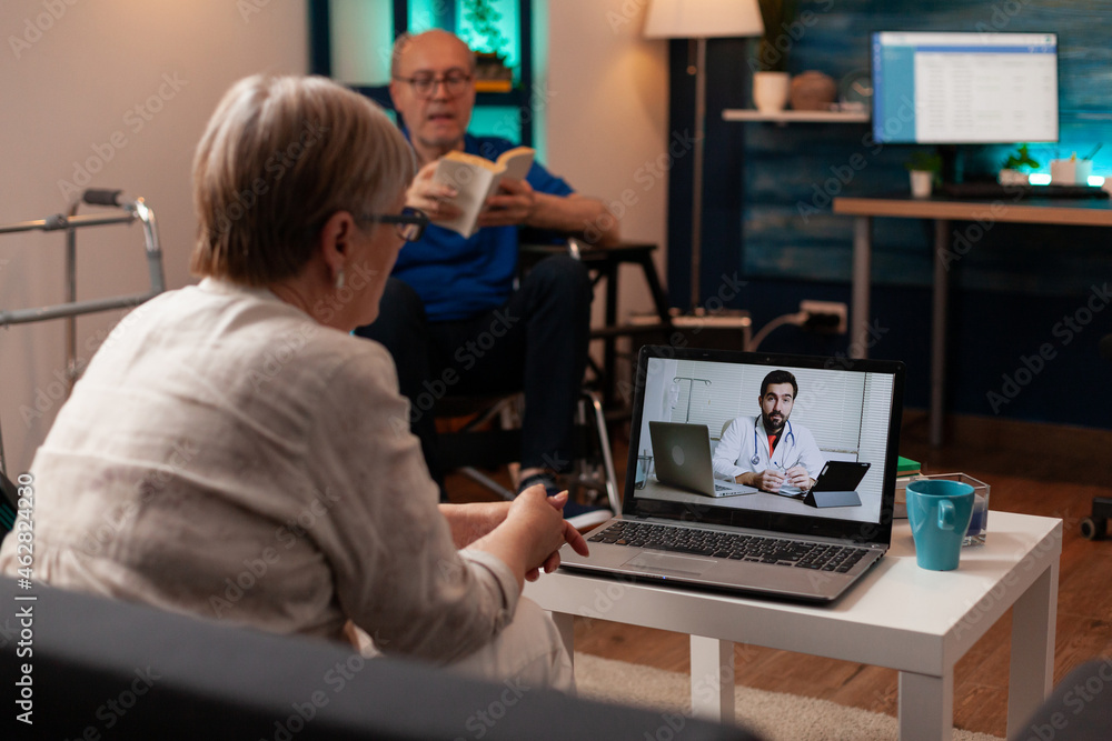 Sick elder patient using telemedicine on video call conference while ...