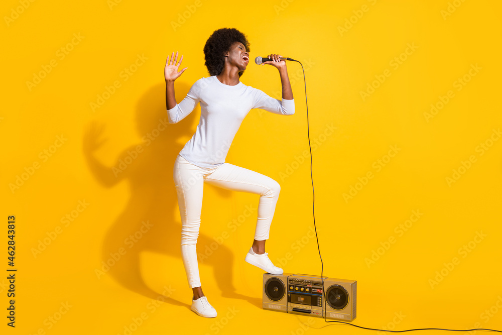 Full size photo of carefree excited dark skin lady singing leg on ...