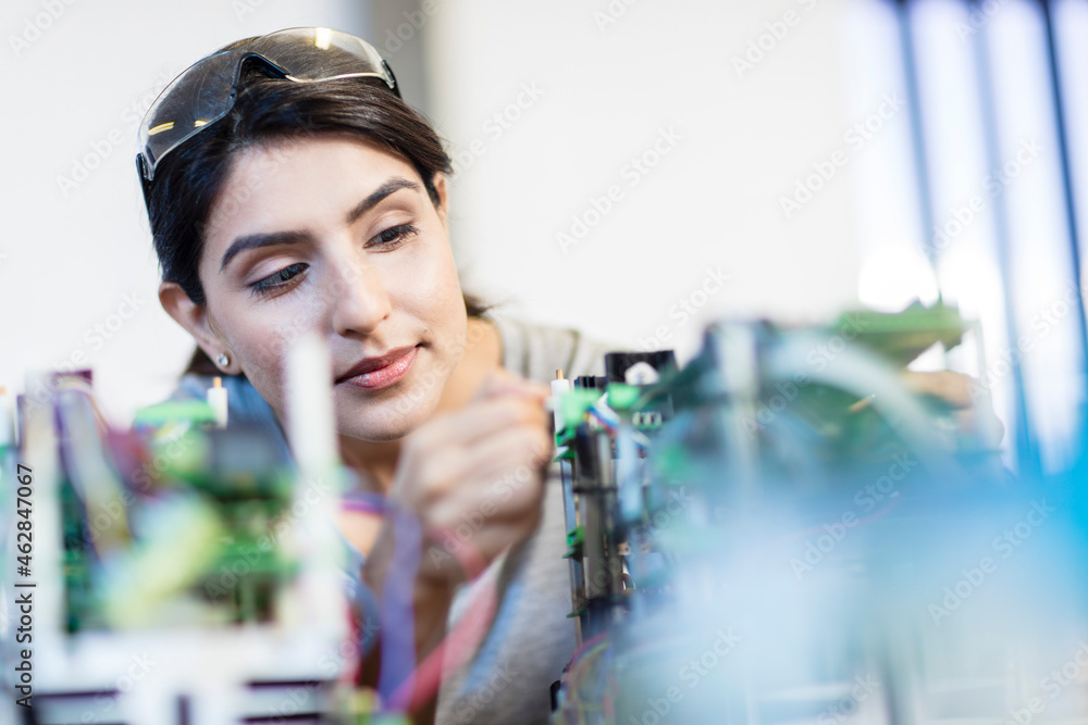 Woman working on motherboard Stock Photo | Adobe Stock