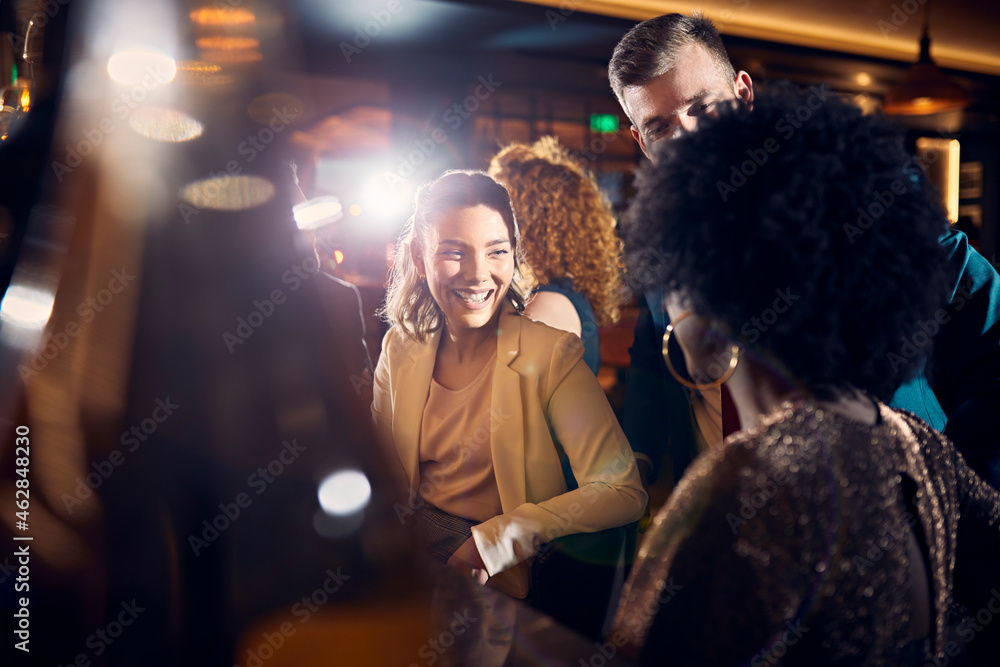 Happy friends socializing in a bar Stock Photo | Adobe Stock