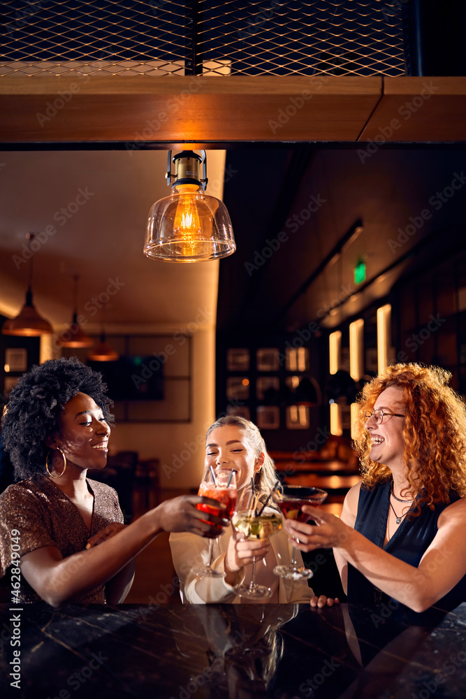 Happy friends socializing in a bar with cocktails Stock Photo | Adobe Stock