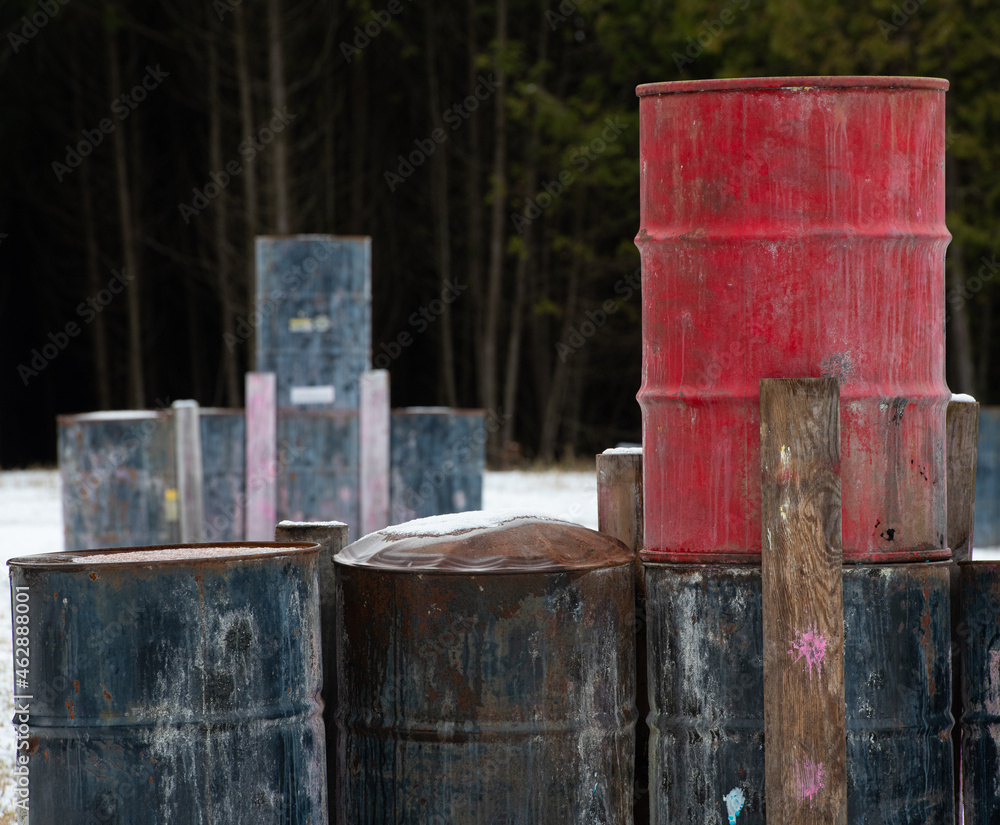 red and blue metal rusty drums or barrels stacked in yard toxic ...