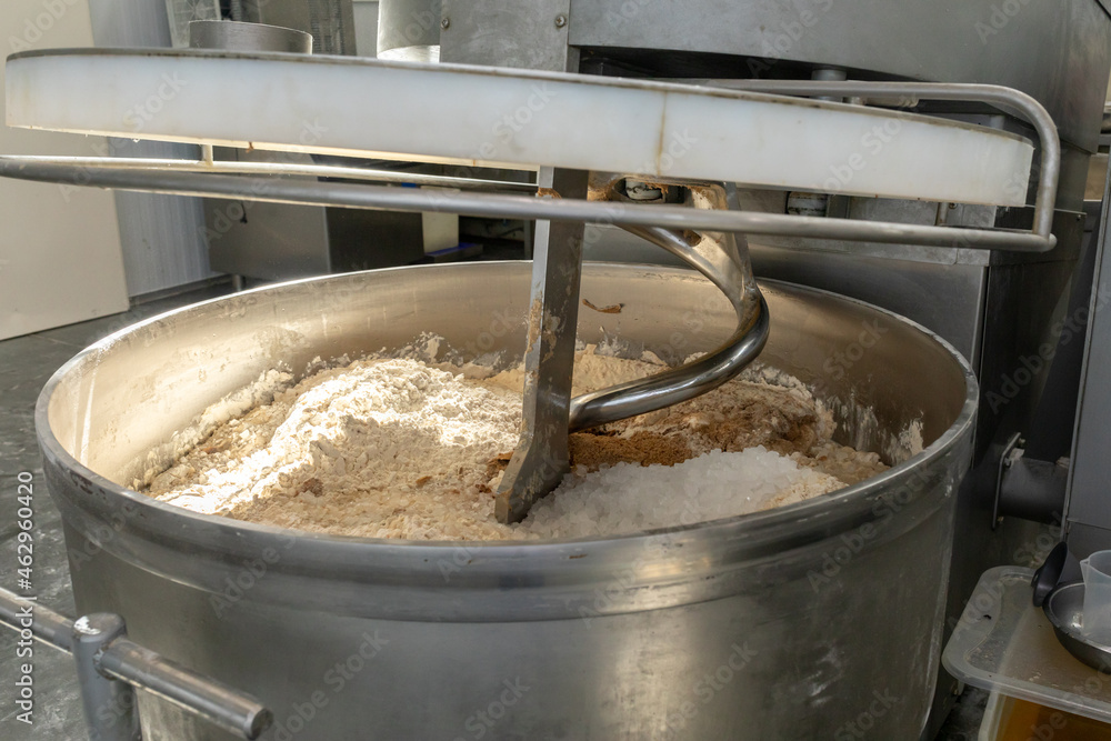 Industrial mixer with flour, salt, sugar, yeast for production of bread ...