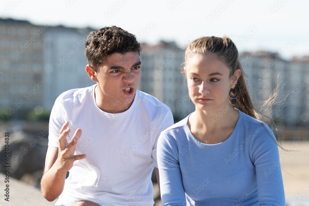 Angry teenager boy shouting to her sad girlfriend. Toxic relationship ...