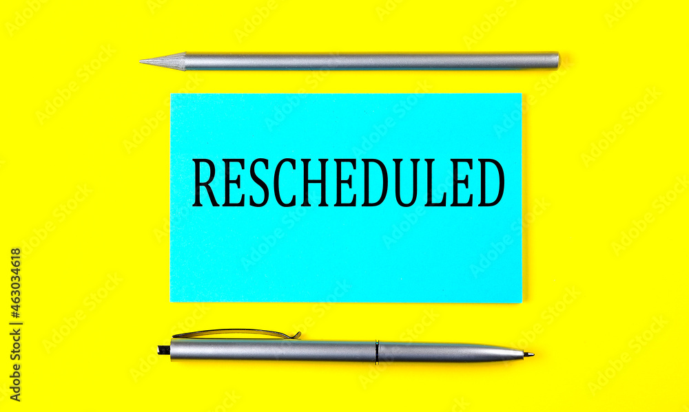 text Rescheduled on the blue sticker on the yellow background Stock ...