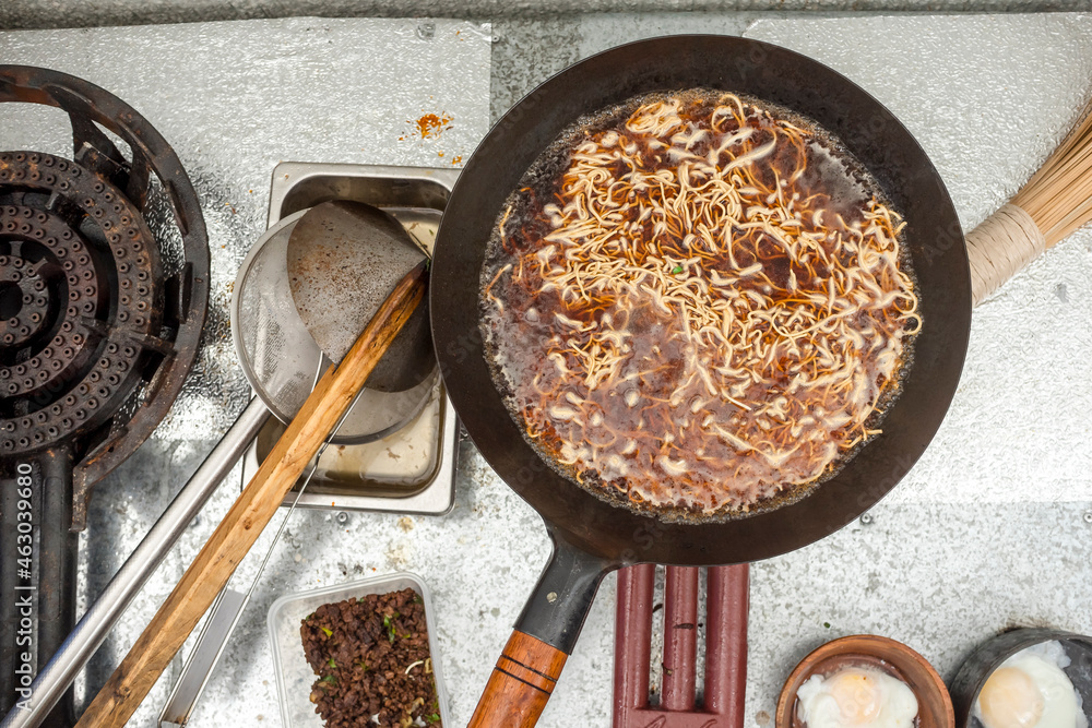 Cooking Miki Noodles on a gas burner. Ingredients for Pancit Cabagan, a ...