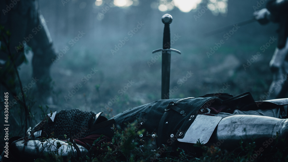Shot of a Dark Age Battlefield: Dead Body With Stuck Sword. Brutal ...