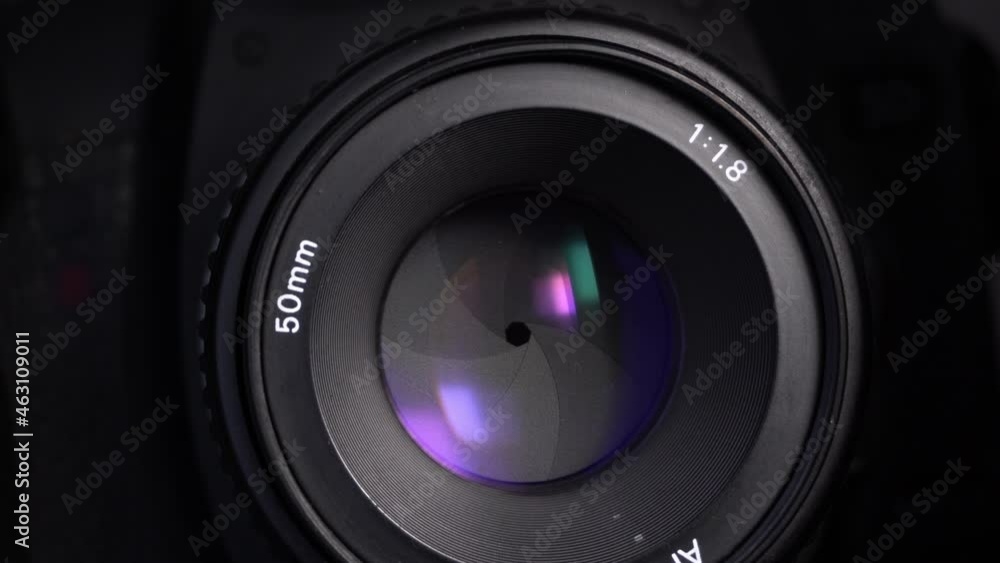 Close-up footage of aperture adjusting in a camera: diaphragm blades of ...