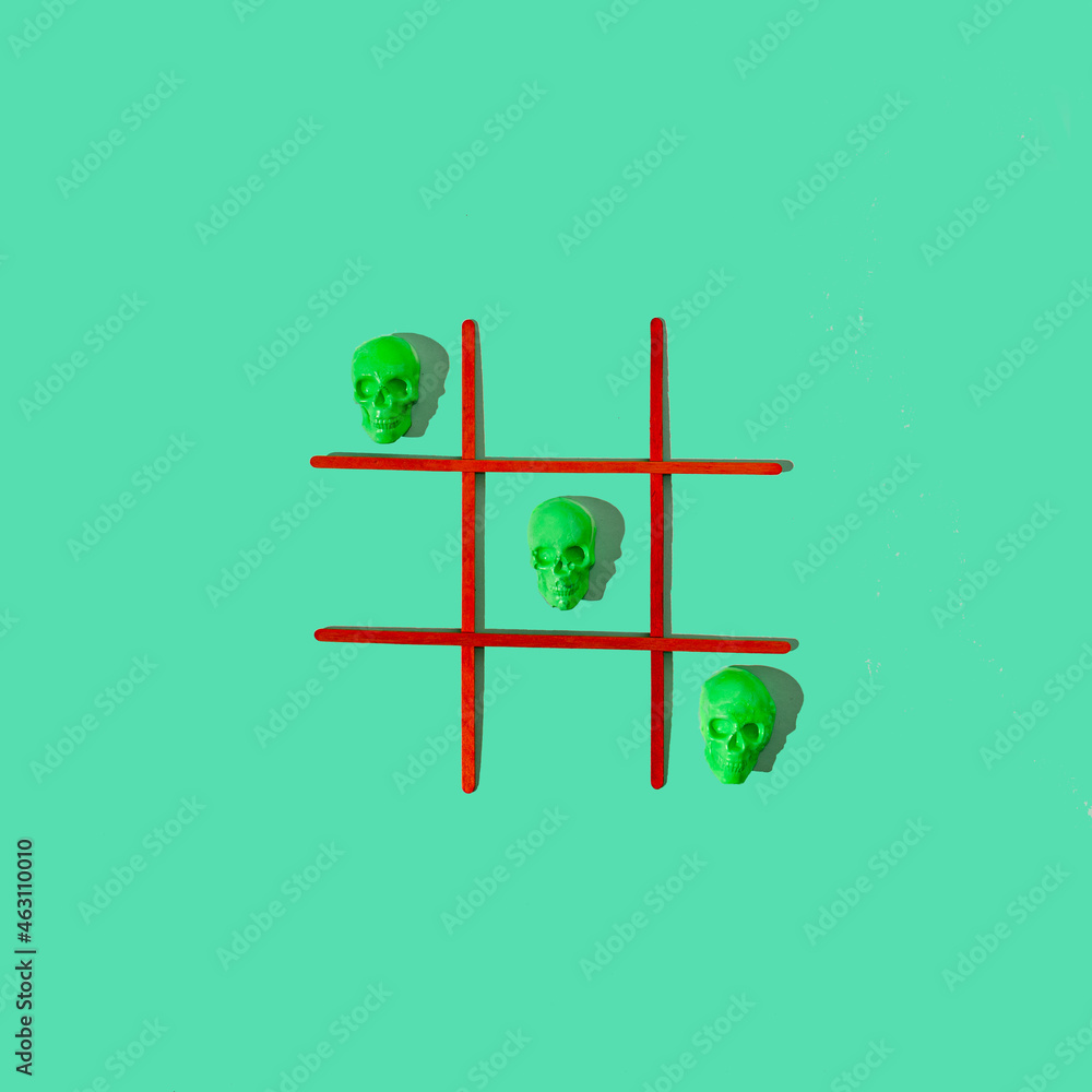 A tic tac toe game with red lines and neon green sculls on lime green ...