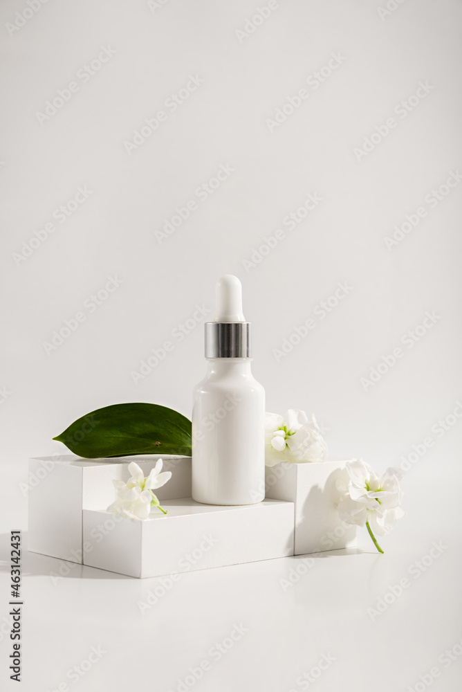 Composition of a white glass dropper bottle with a skin care product ...