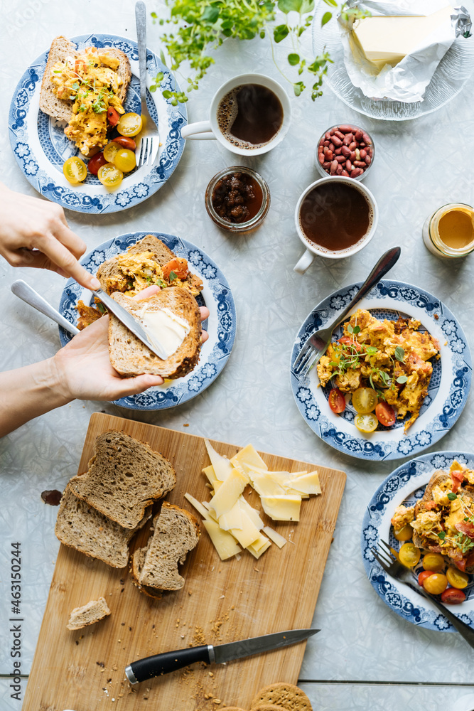 Crop hands smearing butter on toast near breakfast food Stock Photo ...