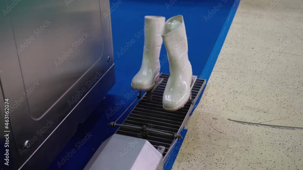 White rubber boots driven on the spot by a motorized mechanical device ...
