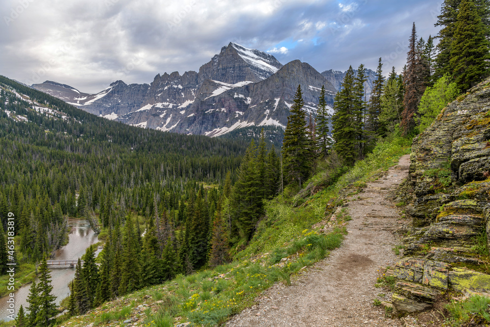 Grinnell Glacier Trail - A stormy Spring evening view of cliffside ...