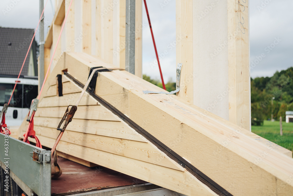 Apex truss with timber cladding being hoisted into place Stock Photo ...