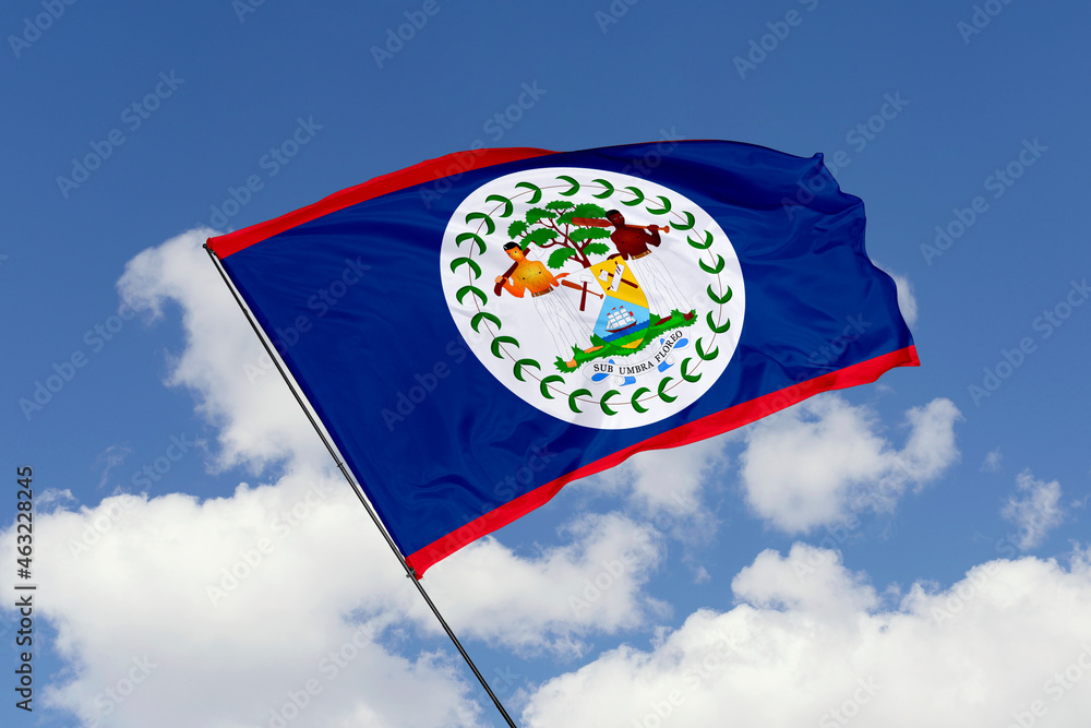 Belize flag isolated on the blue sky background. close up waving flag ...