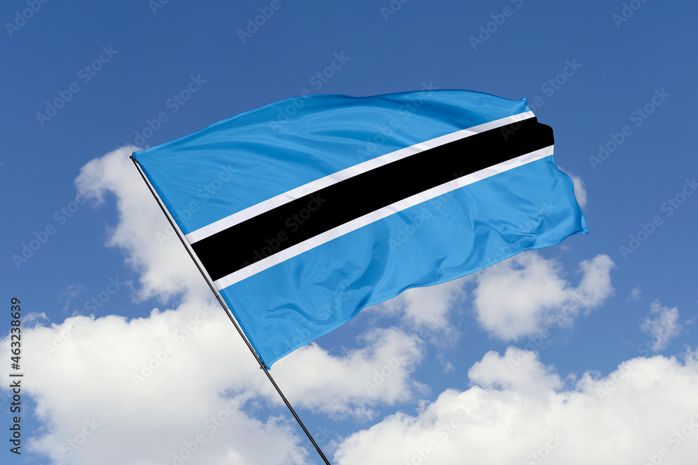 Botswana flag isolated on the blue sky background. close up waving flag ...