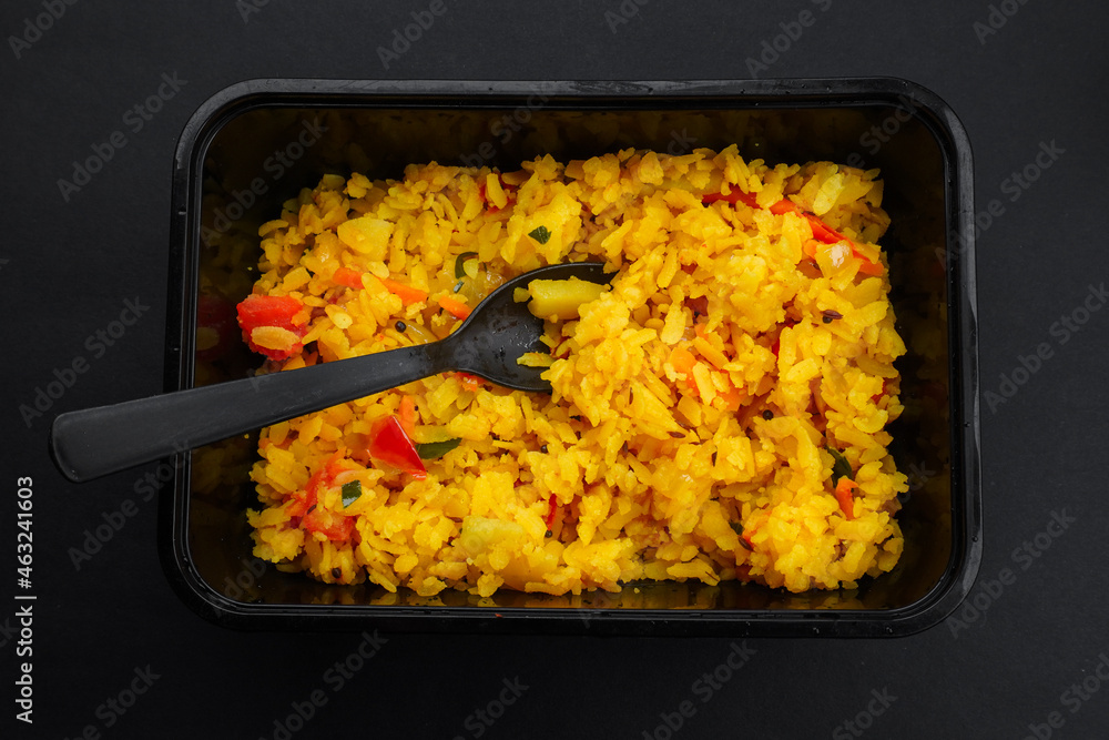 Kaanda poha in the black container, a Maharashtrian snacks consumed in ...