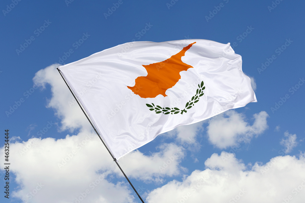 Cyprus flag isolated on the blue sky background. close up waving flag ...