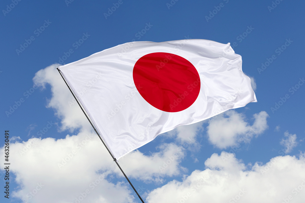Japan flag isolated on the blue sky background. close up waving flag of ...