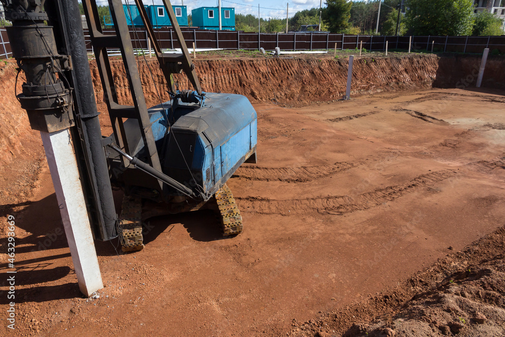Foundation piles drilling machine. Driving piles for the foundation of ...