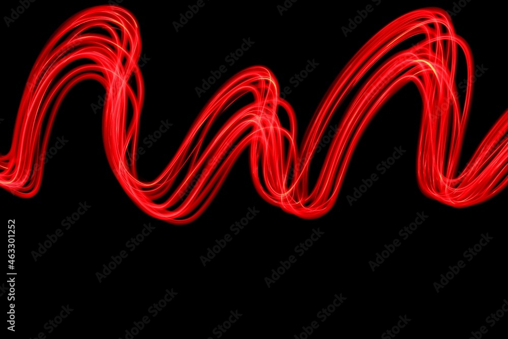 Long exposure photograph of neon red colour in an abstract swirl ...
