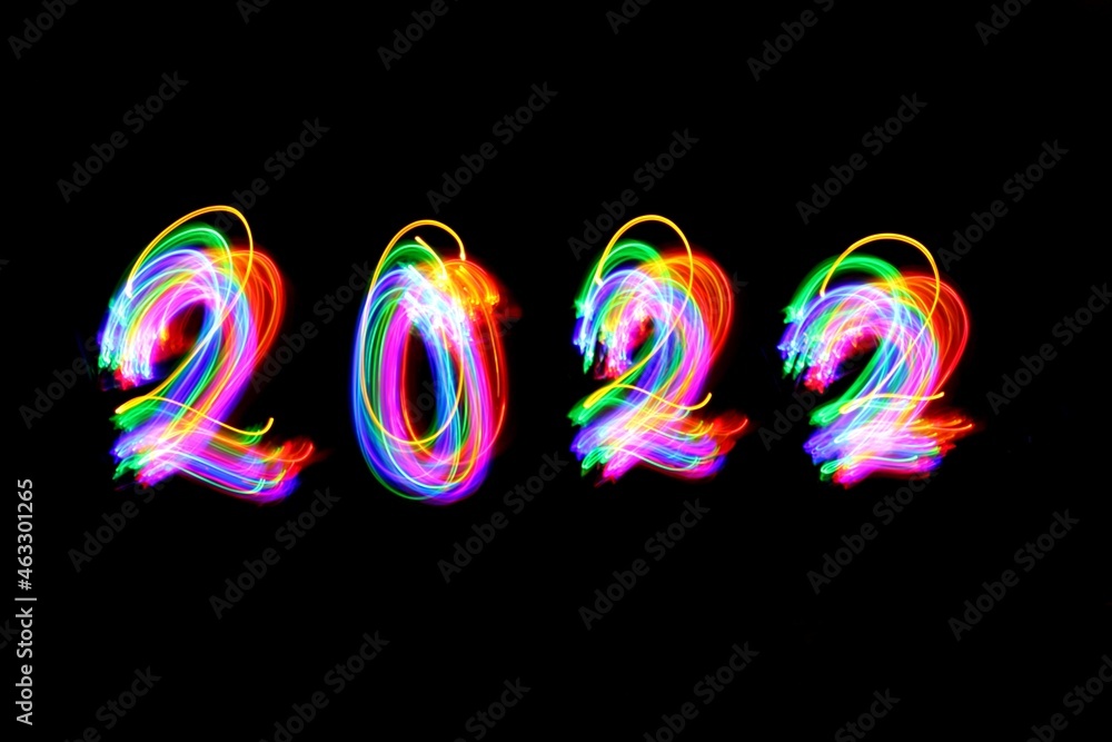 Long exposure photograph of '2022' in neon multi colour in an abstract ...