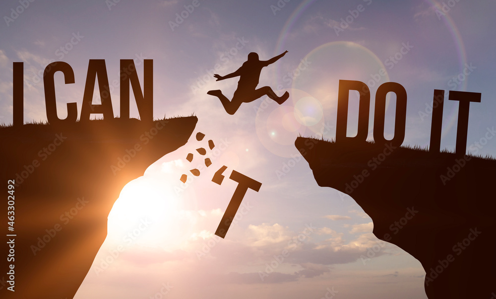 I can't do it and I can do it concept. Man jumping over cliff on sunset ...