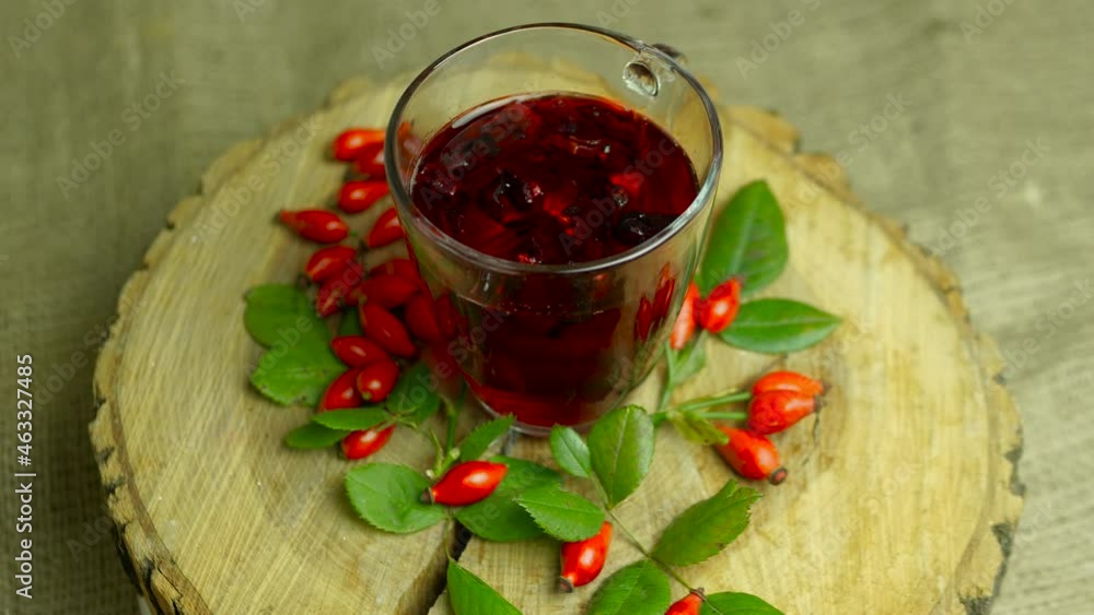Healing herbs and red berries in a cup, tea made from medicinal rose ...