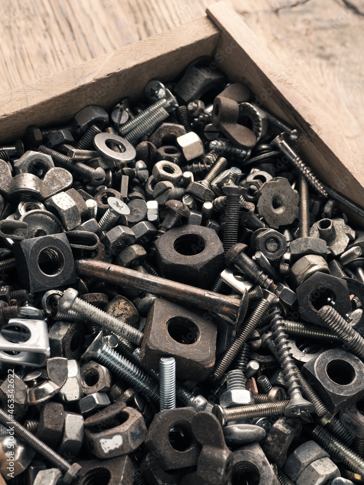 Rusty old bolts and nuts in a wooden box on a rustic workbench Stock ...