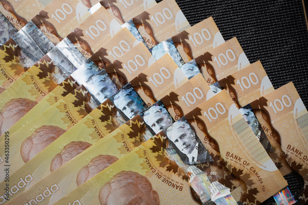 Stack of 100 - hundred Canadian dollar bills on the table. Counting ...