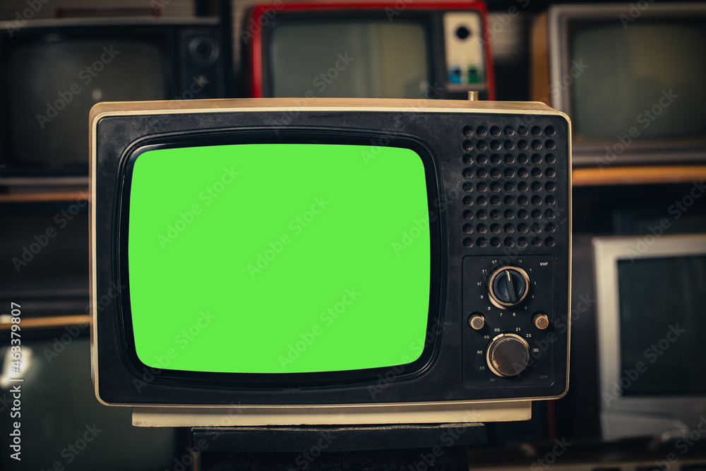 Vintage old TV with green screen in room. Stock Photo | Adobe Stock