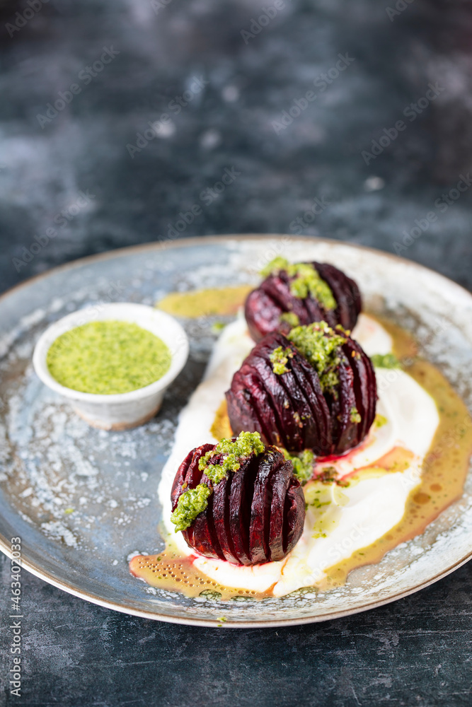 Hasselback roast beetroot with yogurt and herb sauce Stock Photo ...