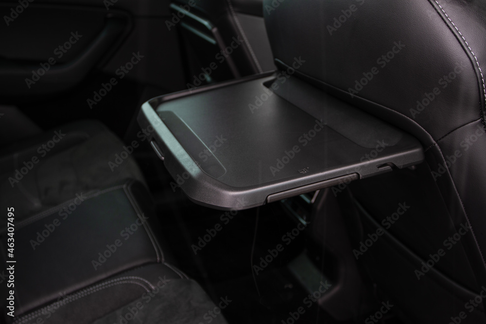 Car folding table inside modern car interior. Folding table on the back ...