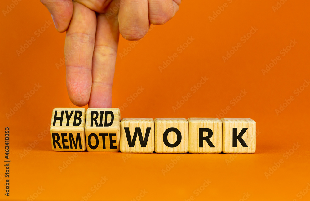 Hybrid or remote work symbol. Businessman turns cubes and changes words ...