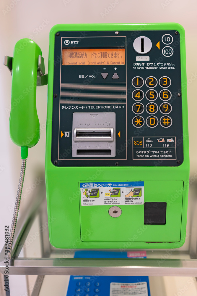 tokyo, japan - august 24 2021: Close up of a green NTT public telephone ...