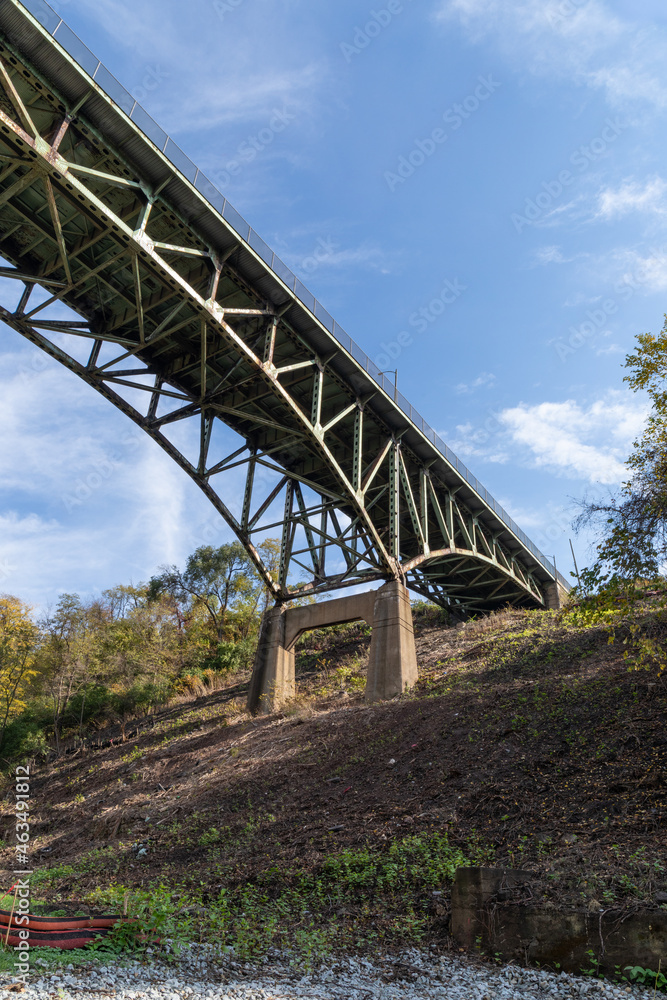 Old arch bridge viewed from beneath showing severe deterioration ...