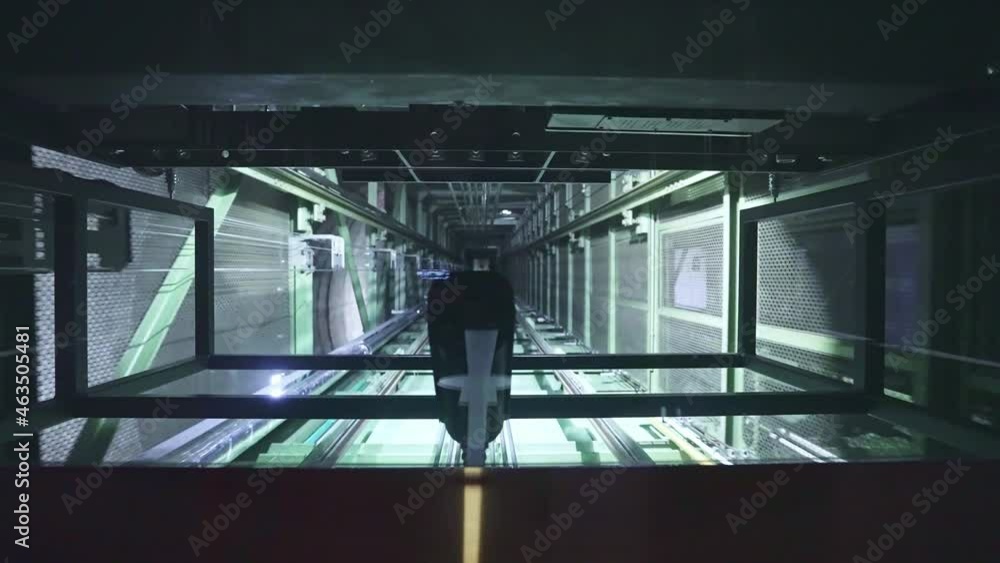 Elevator shaft, hoistway. High speed freight lift in modern industrial ...